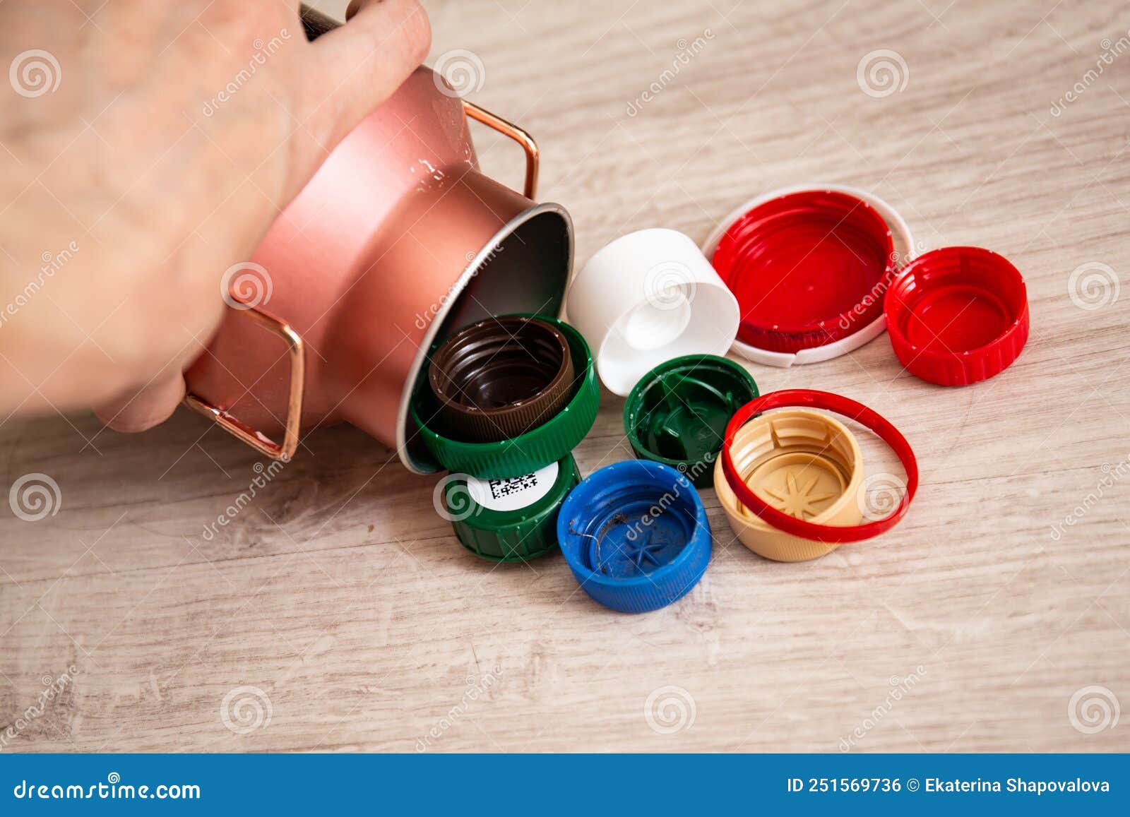 A Hand Holds a Jar and Pours Out Colored Plastic Bottle Caps. Sorting ...
