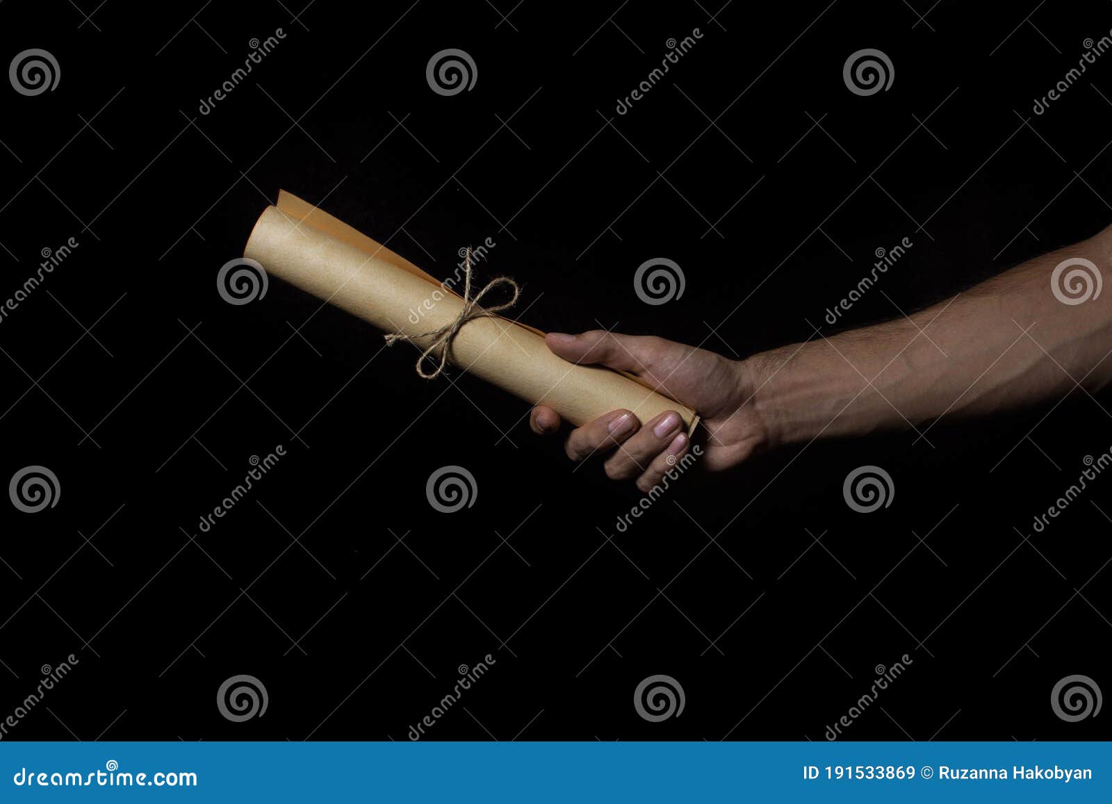 The Hand Holds Out an Old Scroll on a Black Background. Education ...