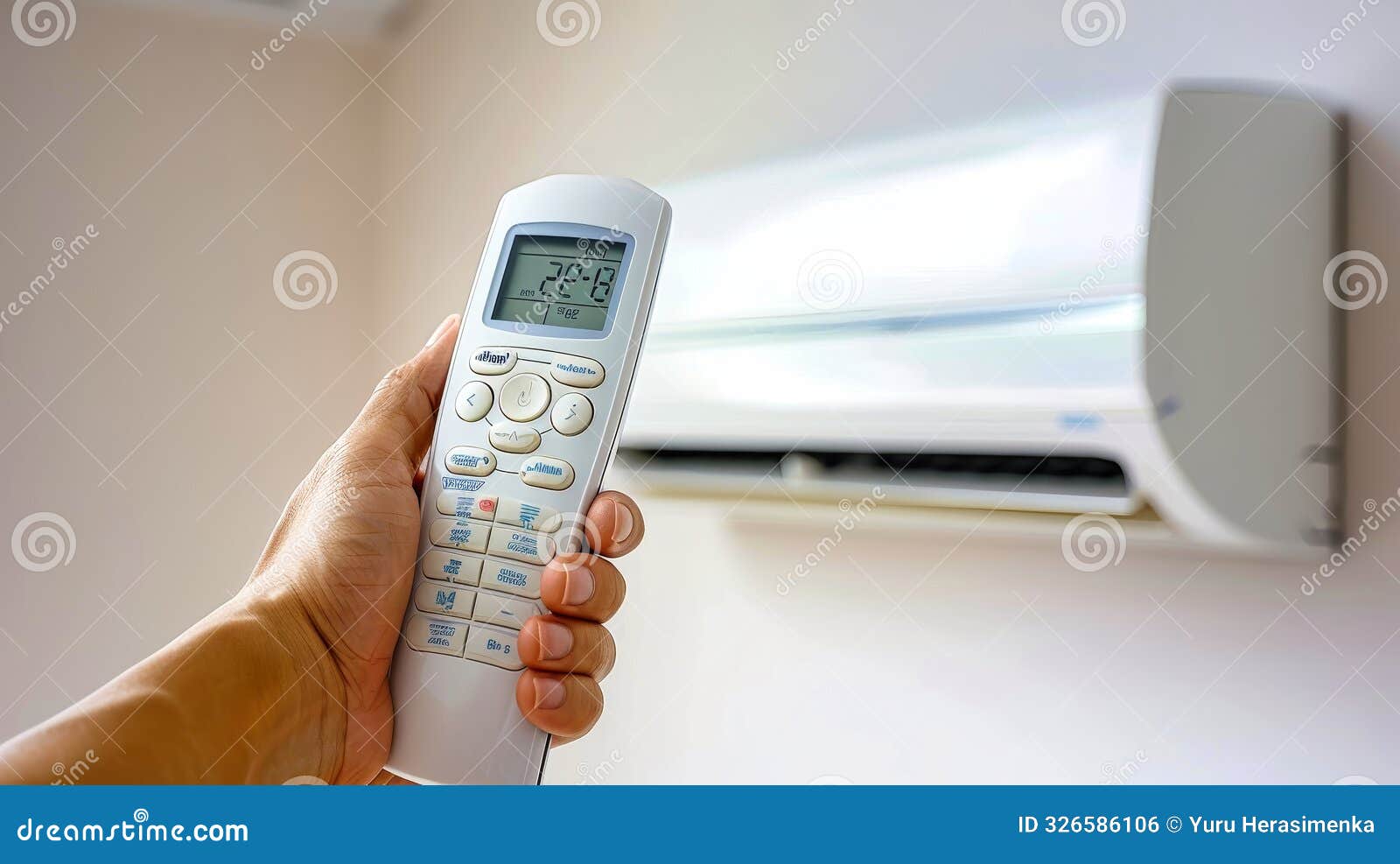 A Hand Holds a Remote Control for an Air Conditioner, Adjusting the ...