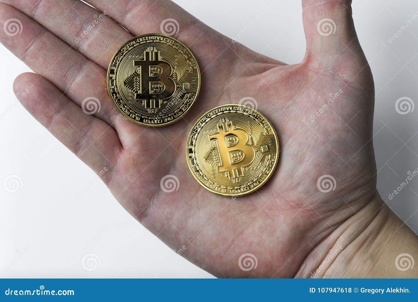 Hand Holds Two Bitcoin On A White Background. Stock Photo - Image of ...