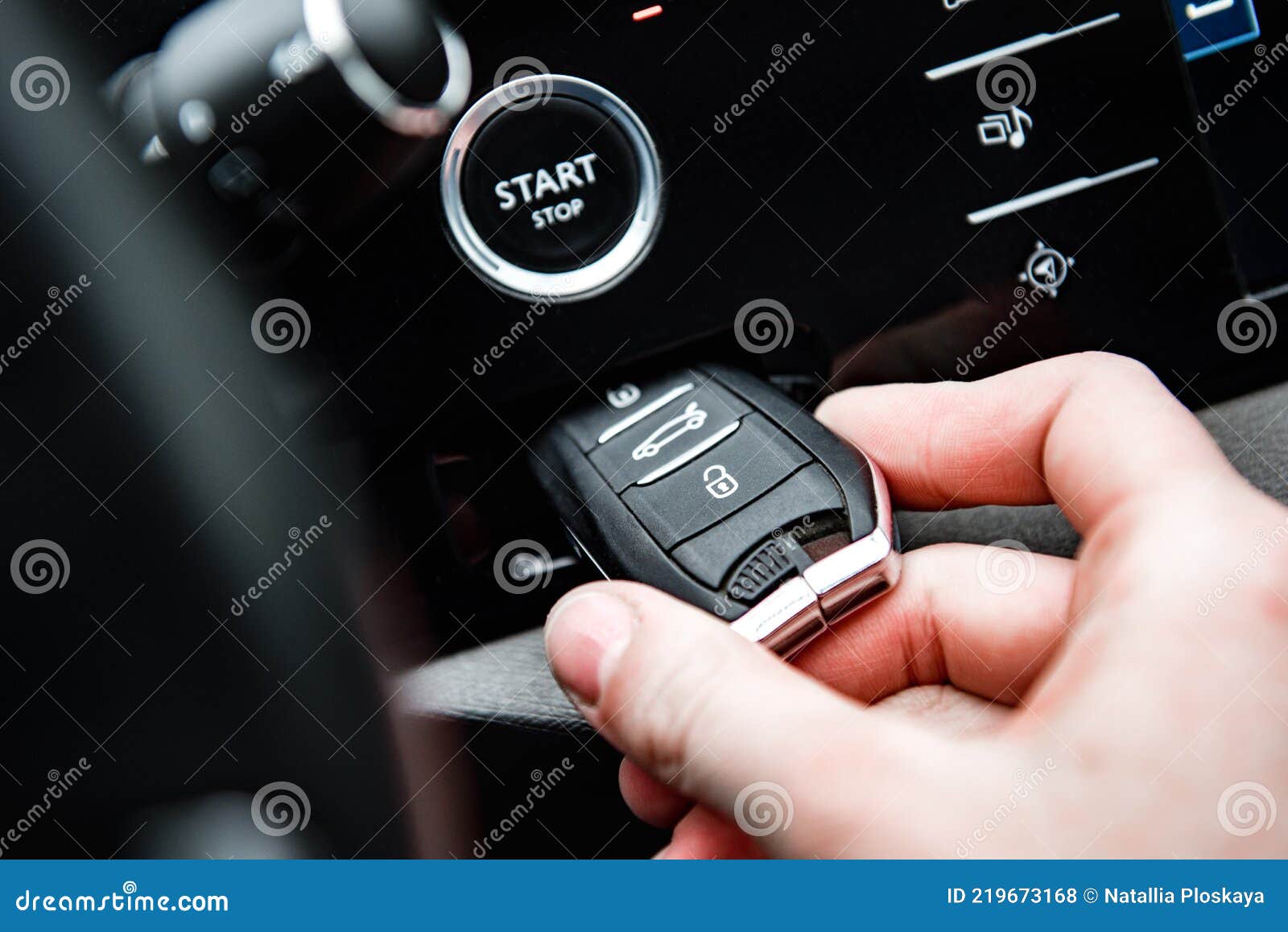 Hand Insert Car Keyless Remote in a Keyhole in a Car with Start Engine ...