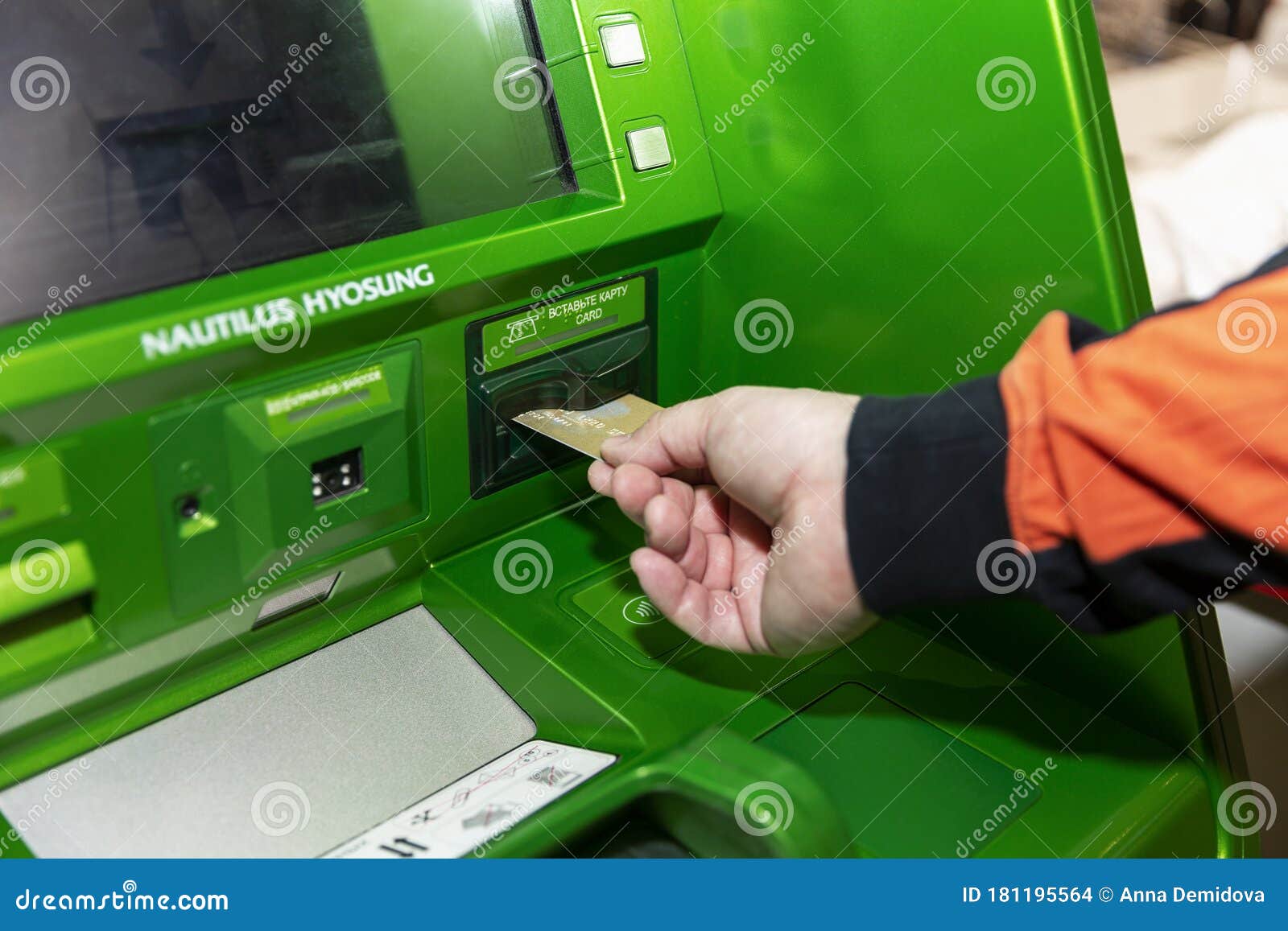 Moscow, Russia, 04/07/2020: Hand Inserting Bank Card into a Green ATM ...