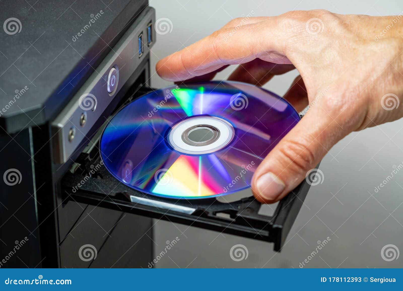 Hand Inserting DVD into a Computer. Closeup. Stock Image - Image of ...
