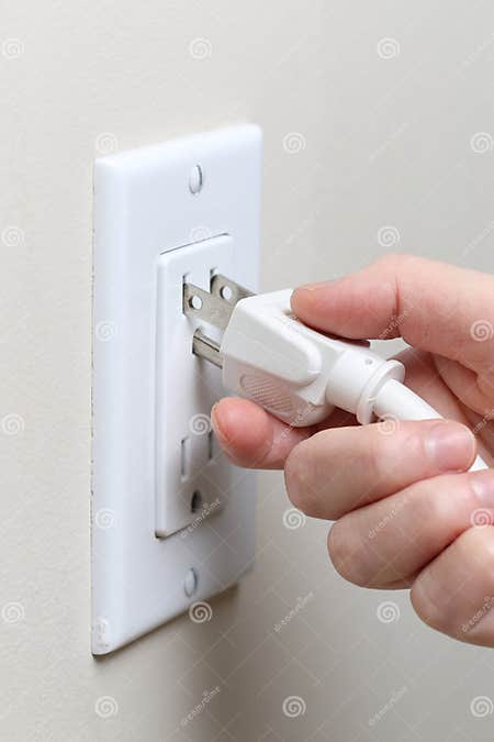 Hand Inserting an Electrical Plug into a Wall Socket Stock Image ...