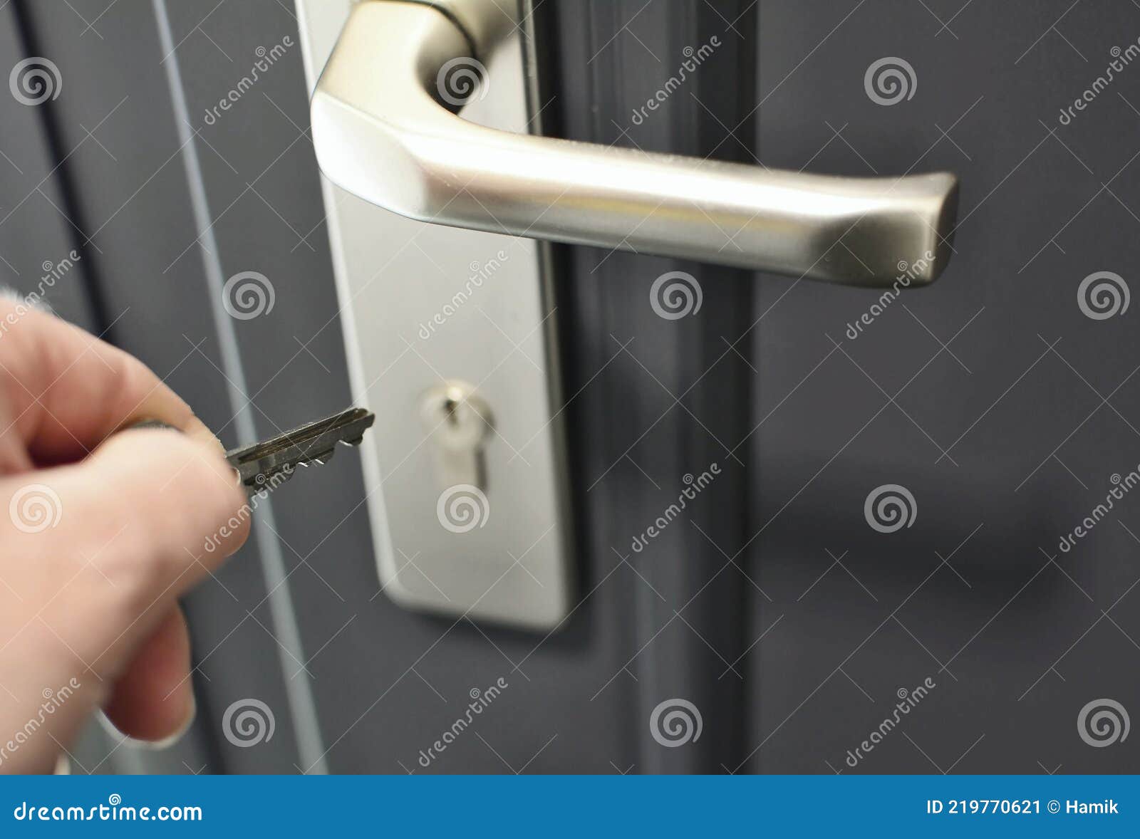 A Hand is Inserting a Key into the Door Lock Stock Image - Image of ...