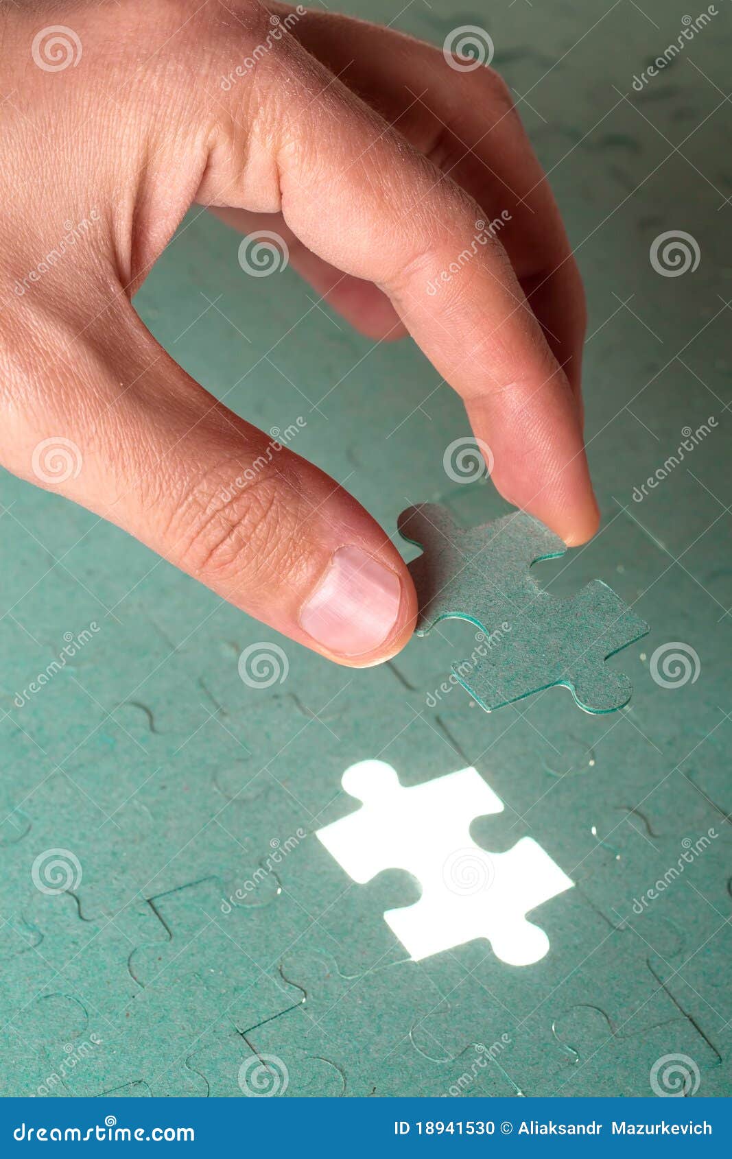 Hand Inserting Missing Piece of Jigsaw Puzzle Stock Photo - Image of ...