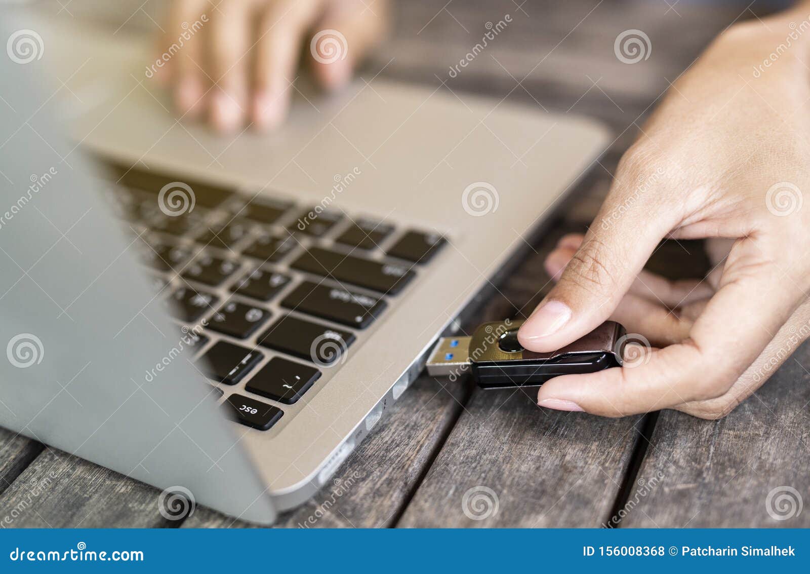 Hand Inserting USB Flash Drive into Computer Laptop on the Desk. Stock ...