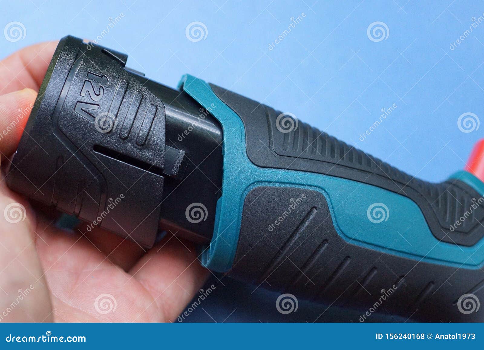 Hand Inserts a Black Plastic Battery into the Handle of a Screwdriver ...