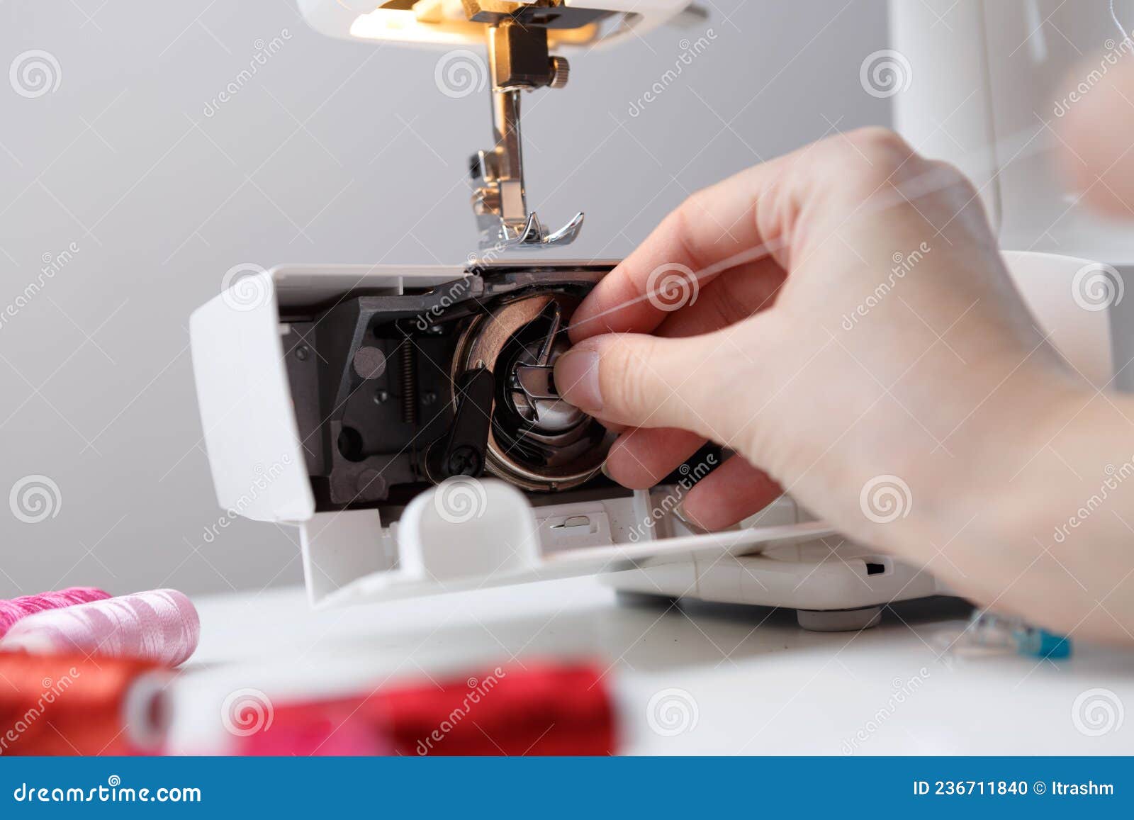 Hand Inserts Bobbin in Sewing-machine Stock Photo - Image of machine ...