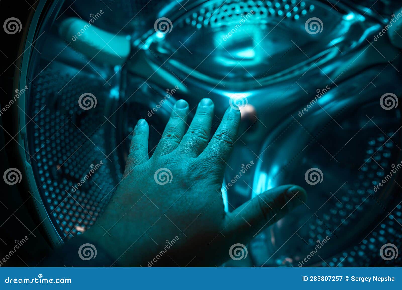 A Hand Inside Washer in a Blue Light, Concept Stock Image - Image of ...