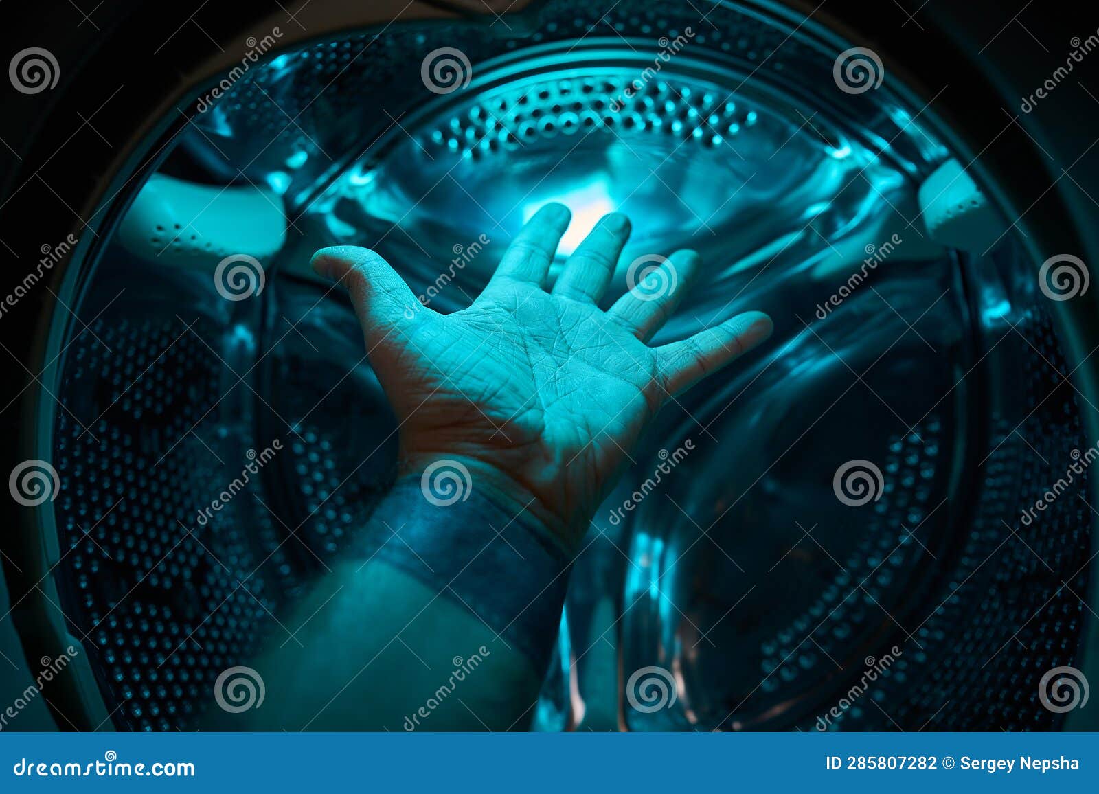 A Hand Inside Washer in a Blue Light, Concept Stock Photo - Image of ...