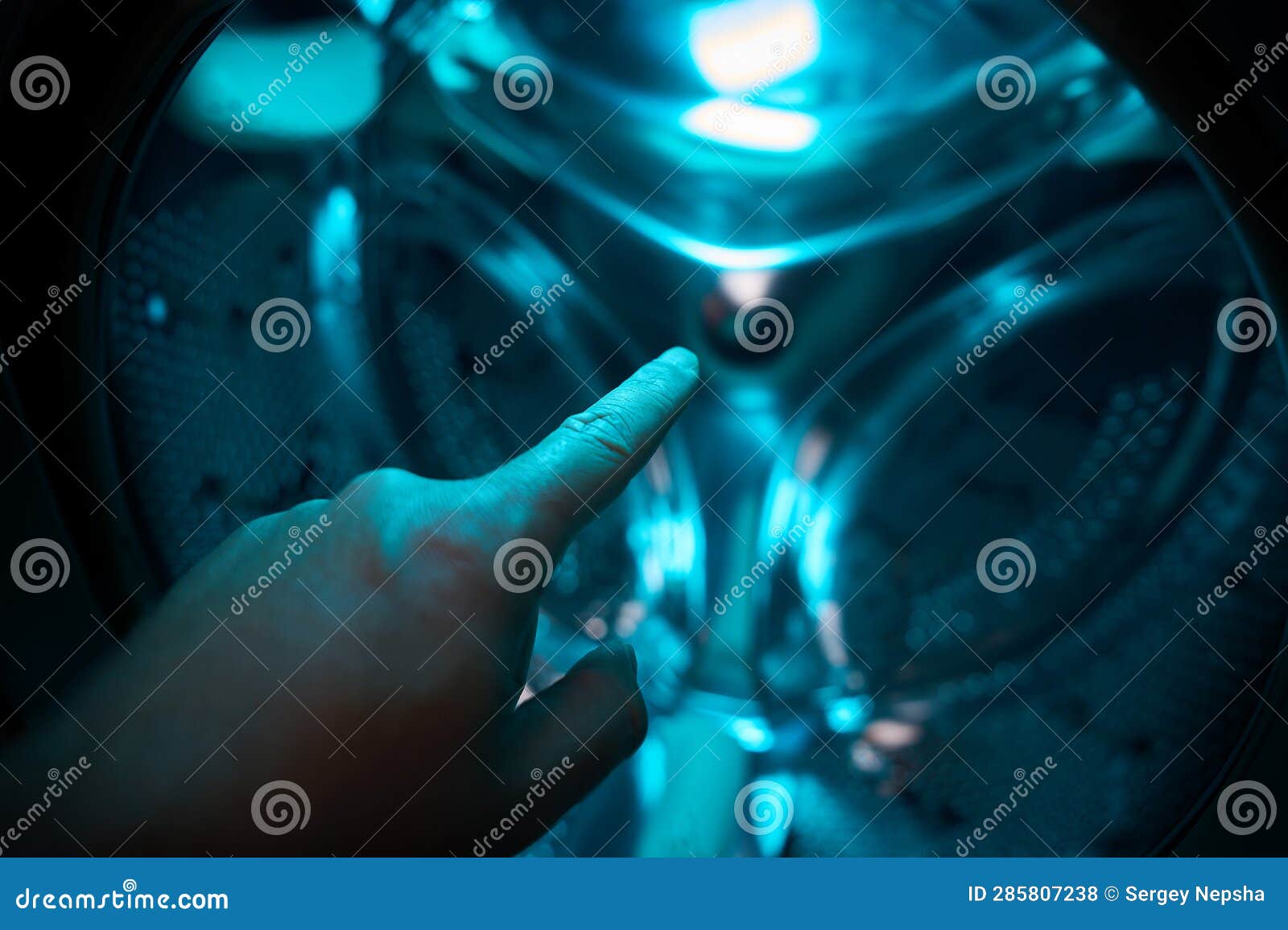 A Hand Inside Washer Pointing a Finger Stock Photo - Image of space ...