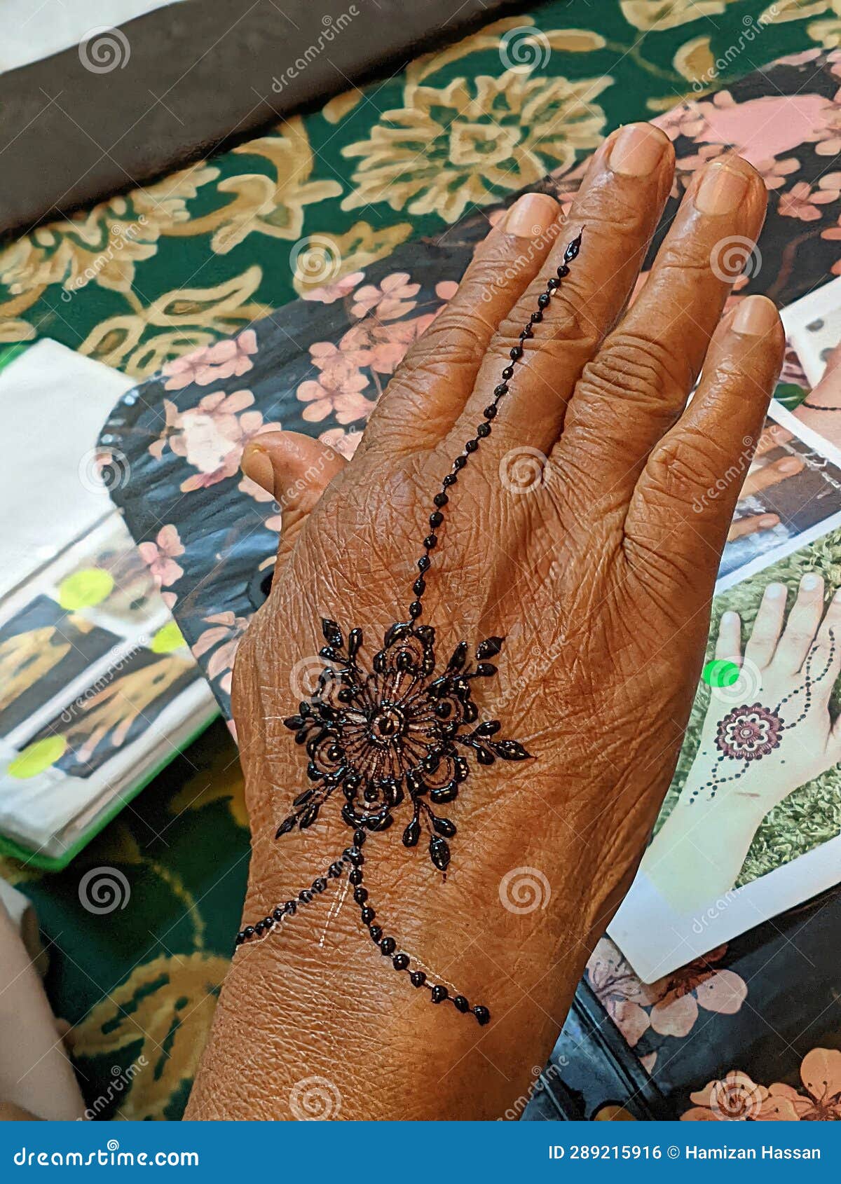 A Hand with Intricate Henna Designs, Swirling Patterns in Reddish-brown ...