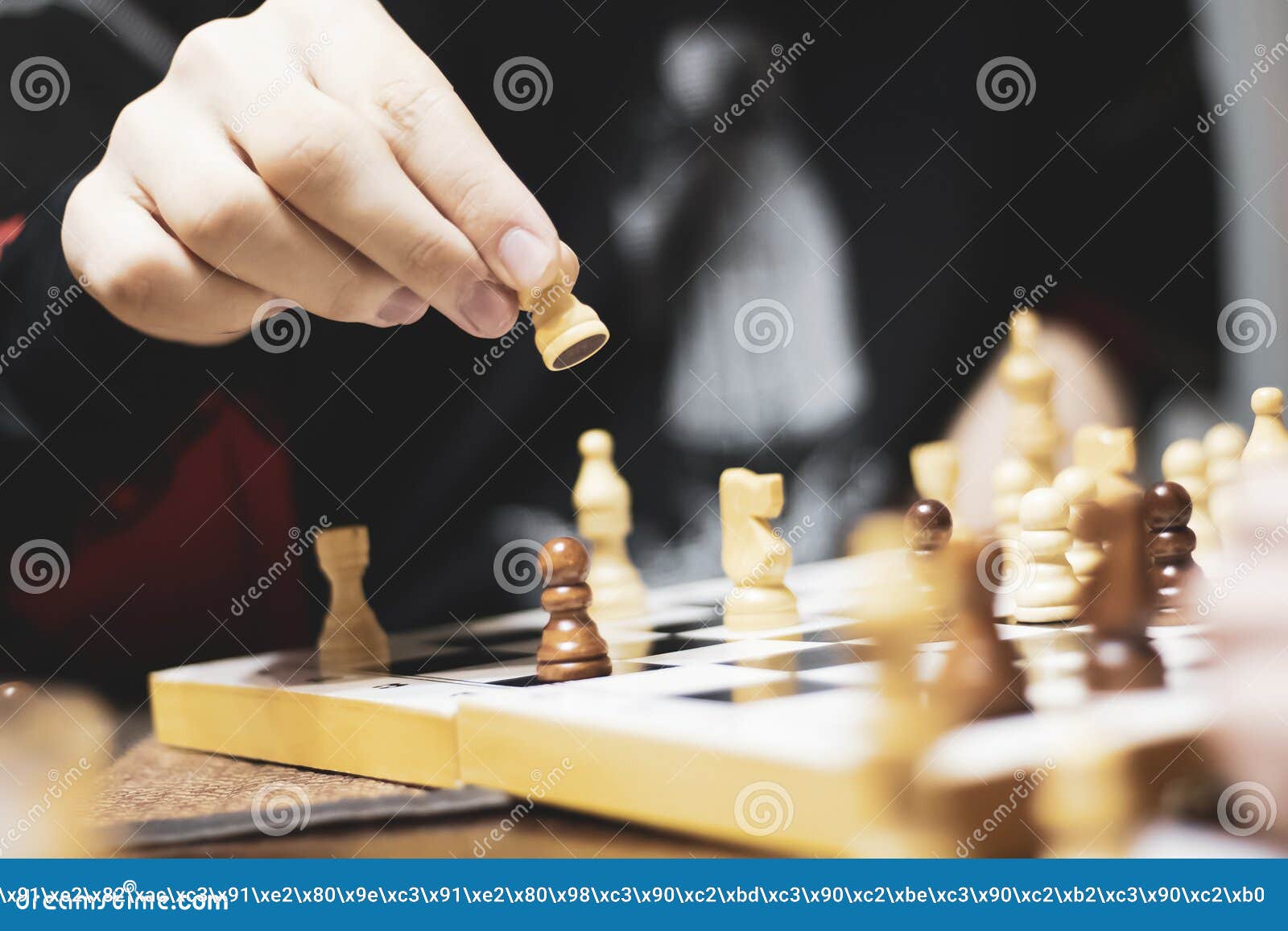 The Hand Keeps the Chess Piece in Focus, the Rest of the Chess Game is ...