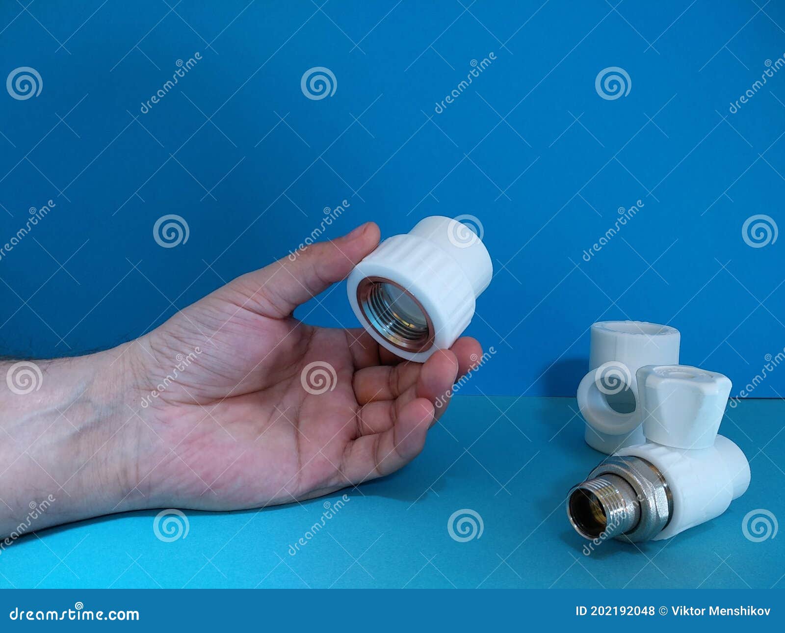 Hand Keeps White Polypropylene Pipe Fittings on Blue Background Stock ...