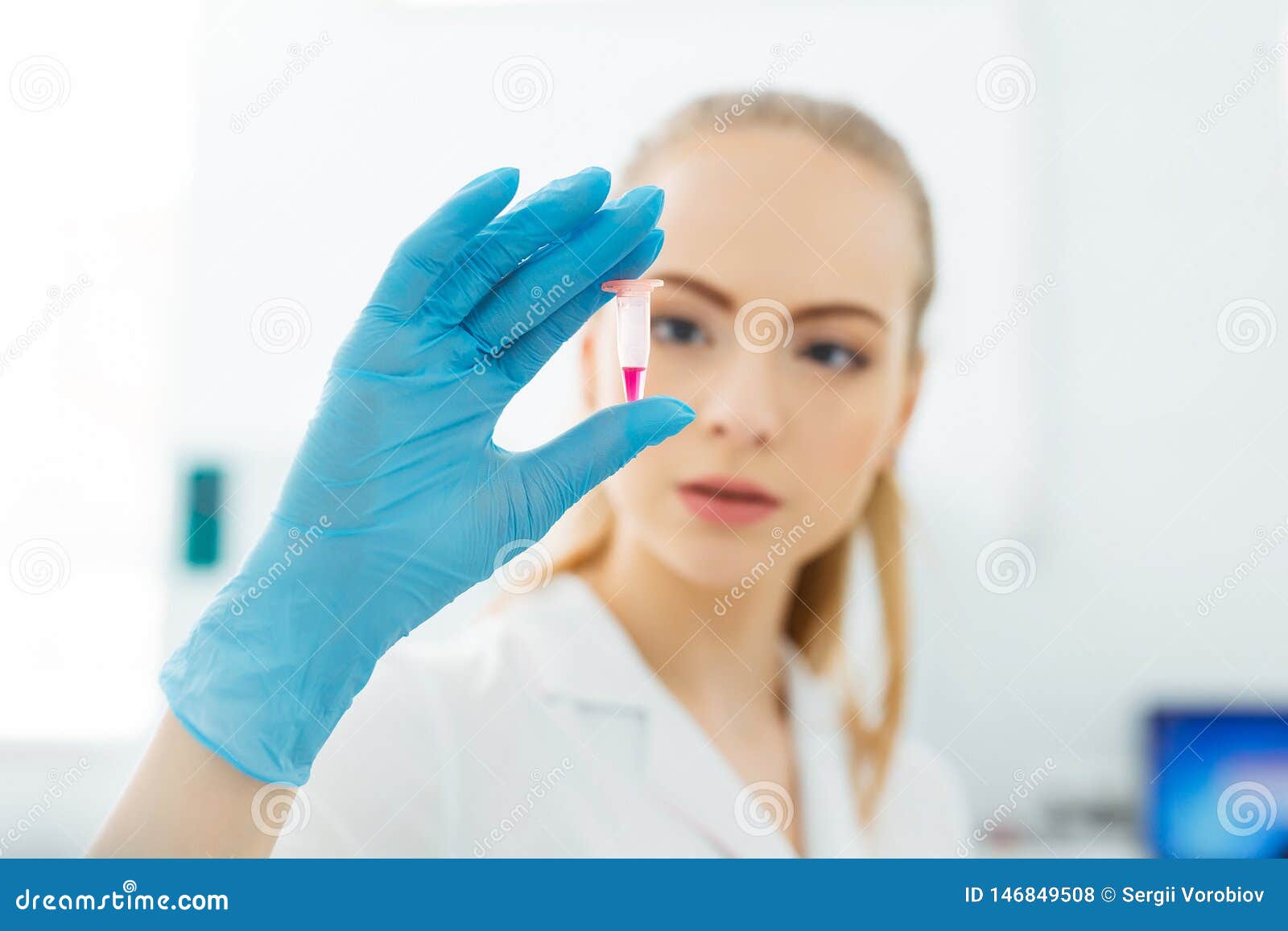 Hand of a Lab Technician Holding a Mini Test Tube with Blood Sample for ...