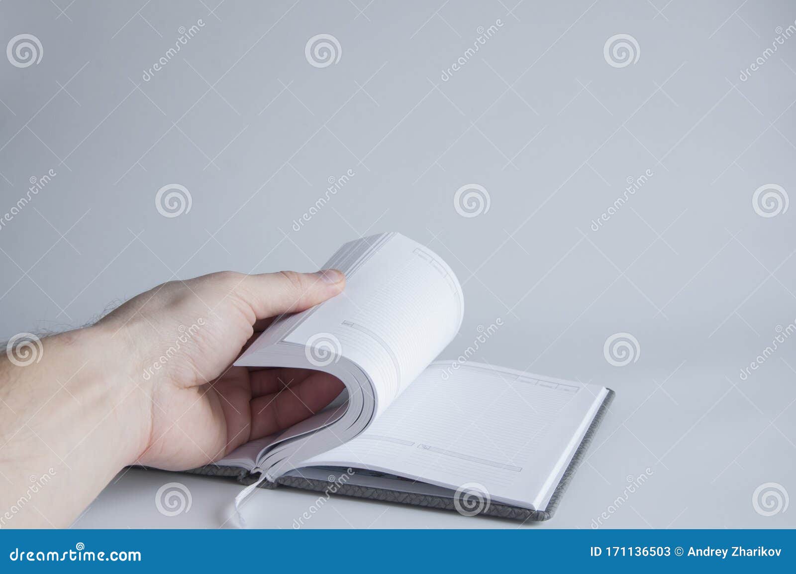 Hand Leafing through Pages of a Book or Notepad. on White Background ...