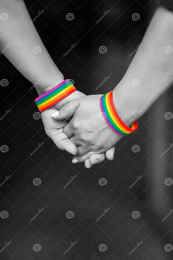 Hand Of Lgbt Women Holding Together With Rainbow Ribbon Symbol Concept