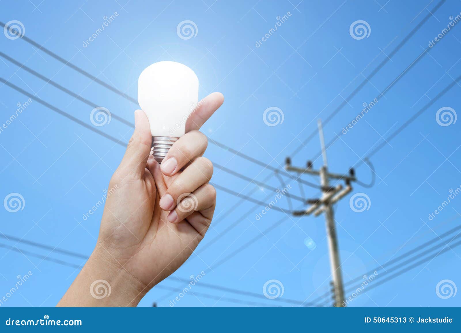 Hand with Light Bulb, Electricity Pole Background Stock Image - Image ...