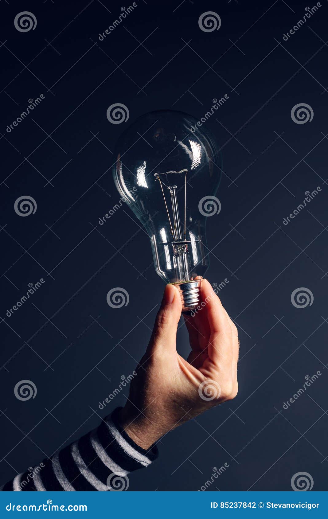 Hand with light bulb stock photo. Image of inspiration - 85237842