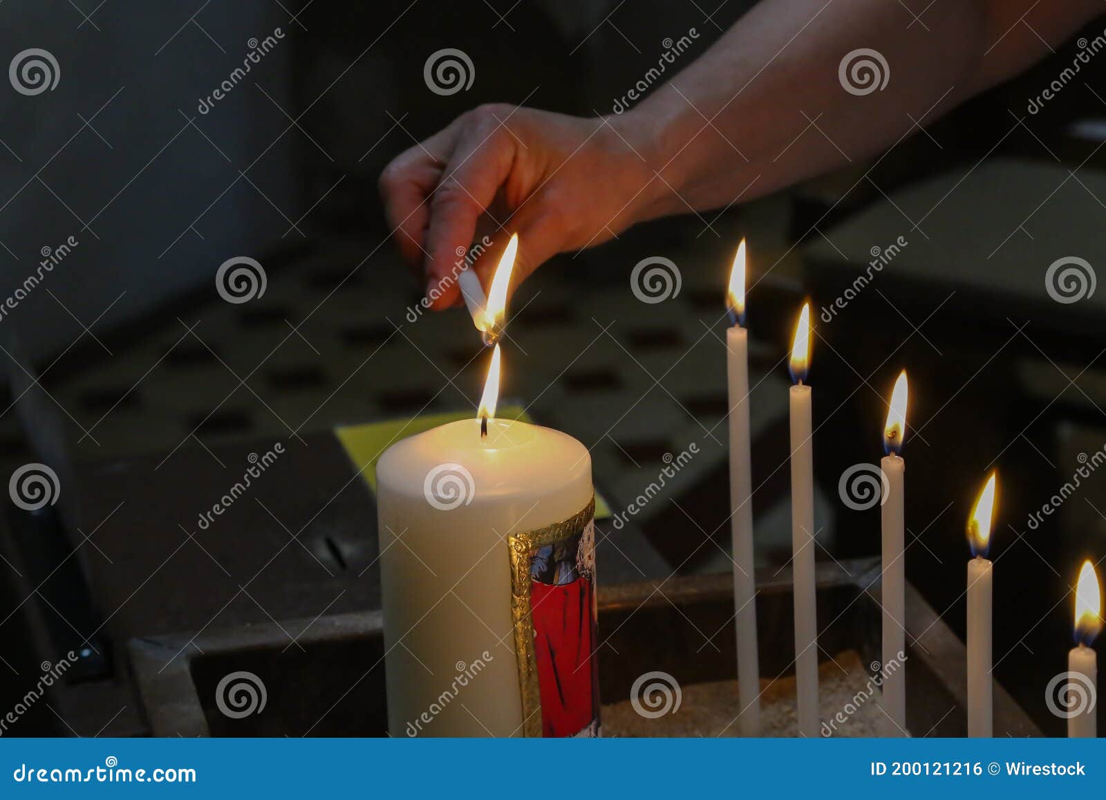 Hand lighting a candle stock photo. Image of fire, light - 200121216
