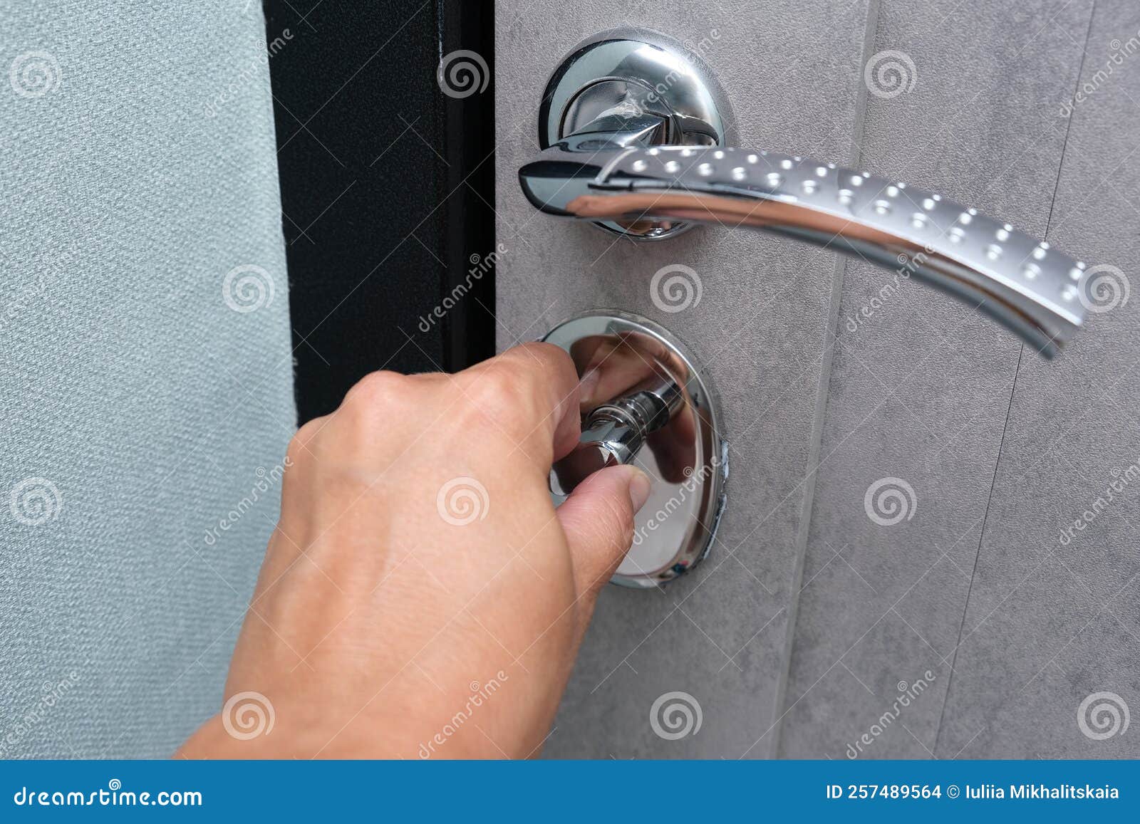 A Hand Locking the Door with a Door Knob for Security, Protection from ...