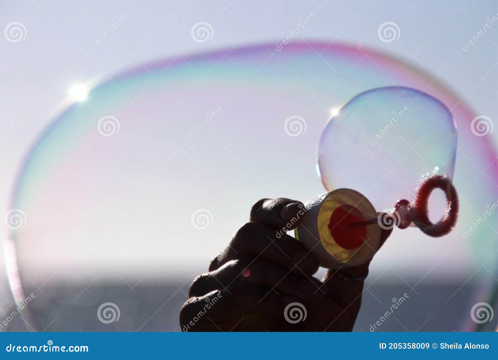 Hand making soap bubbles stock image. Image of global - 205358009