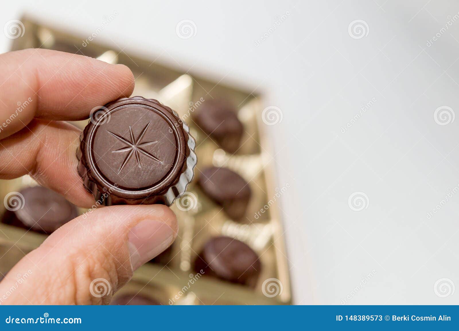 Hand of a Man Holding a Chocolate from a Box of Chocolates Stock Image ...