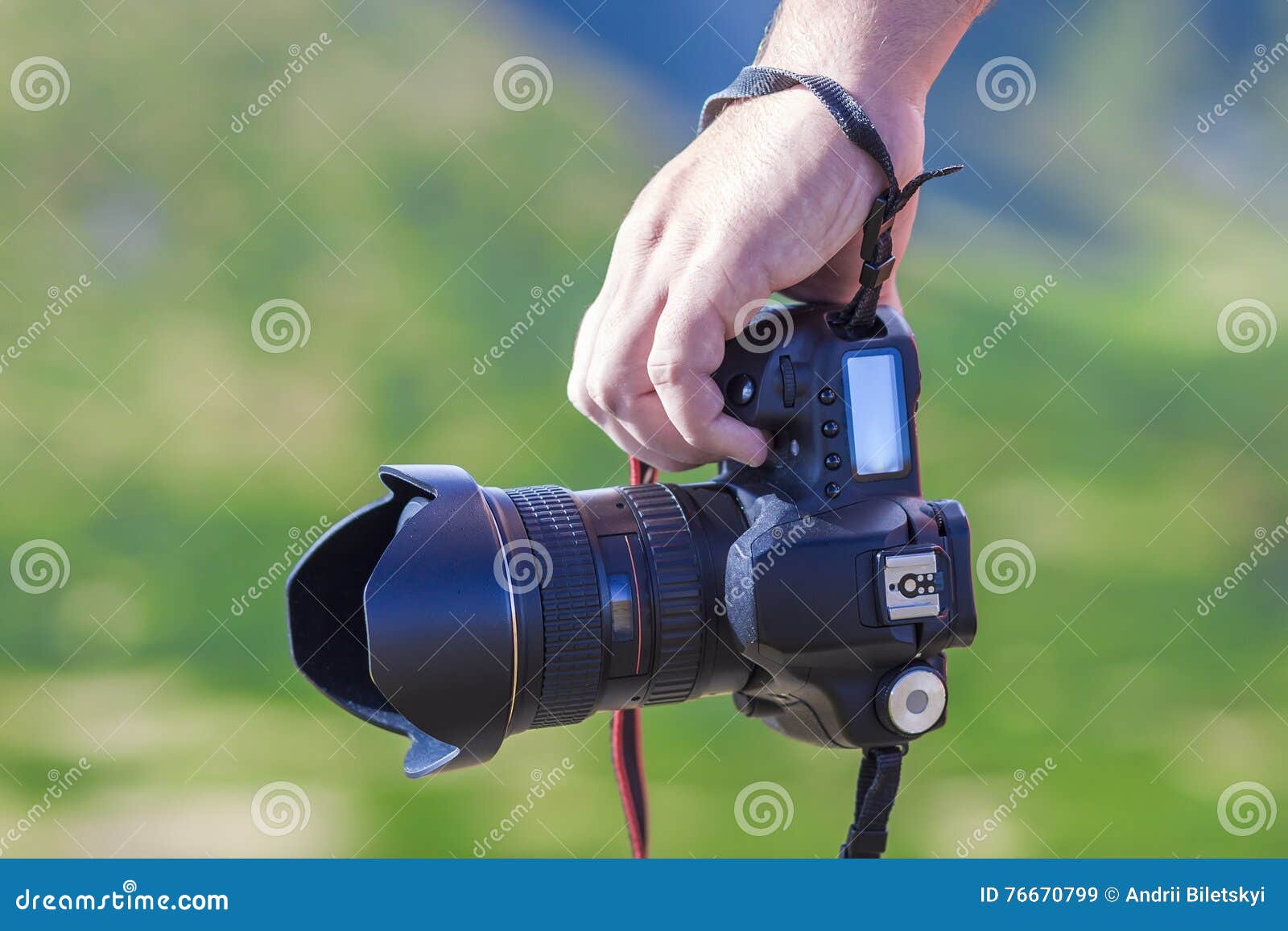 Hand of a Man Holding Professional Digital Camera on Blurred Gre Stock ...