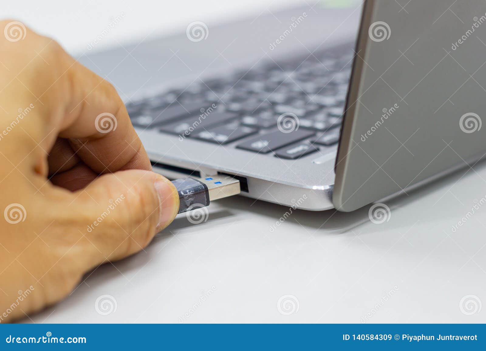 Hand of Man Holding a USB Device Connected To Laptop Computer Stock ...