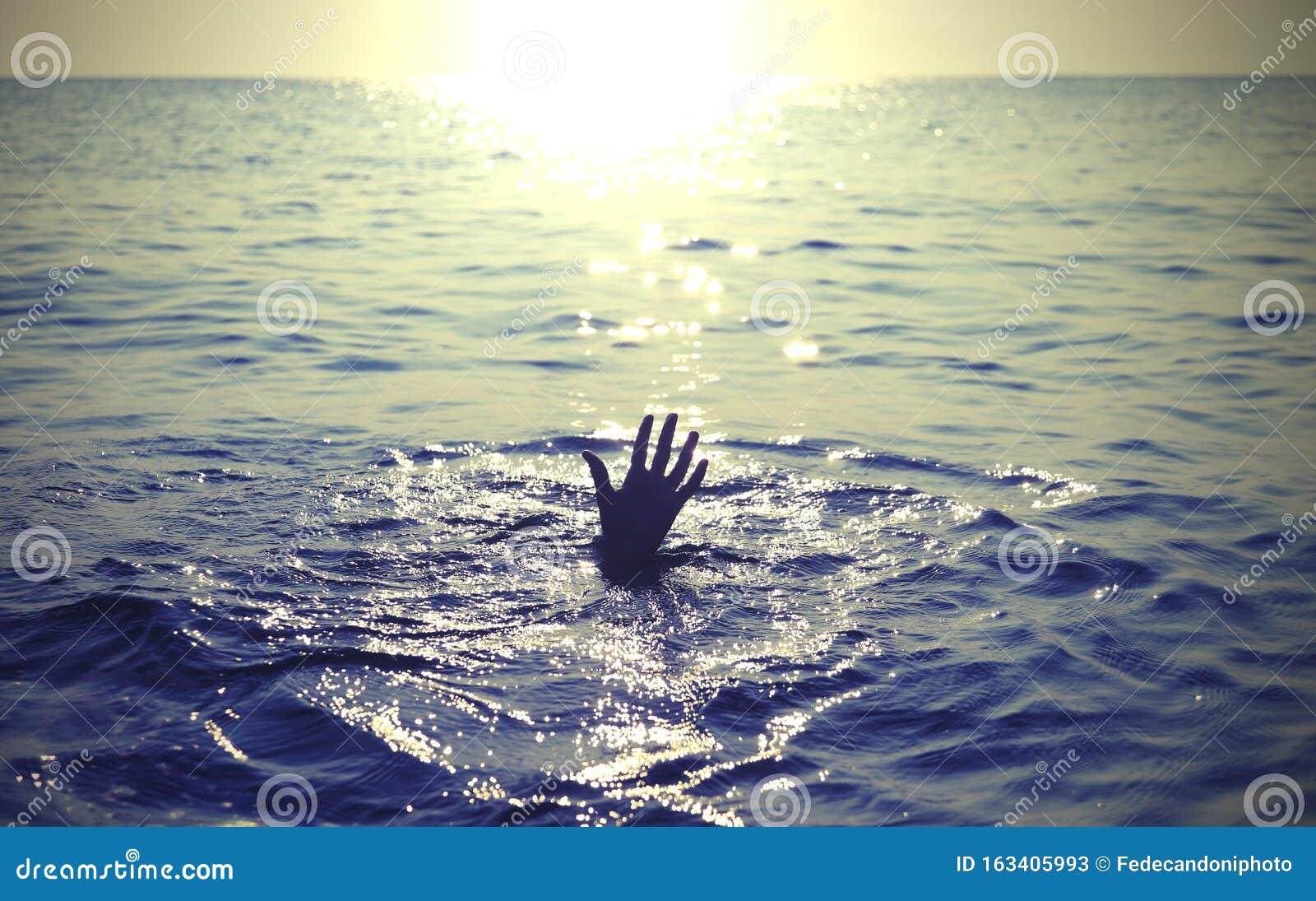 Hand of man on the ocean stock image. Image of person - 163405993