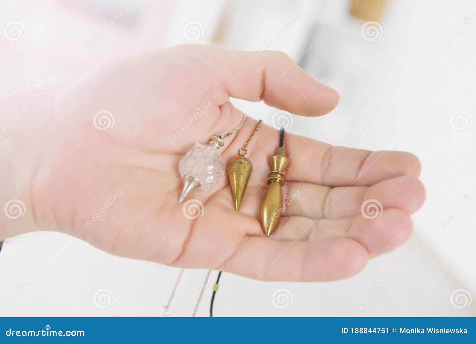 Hand with many pendulums stock image. Image of metaphysical - 188844751