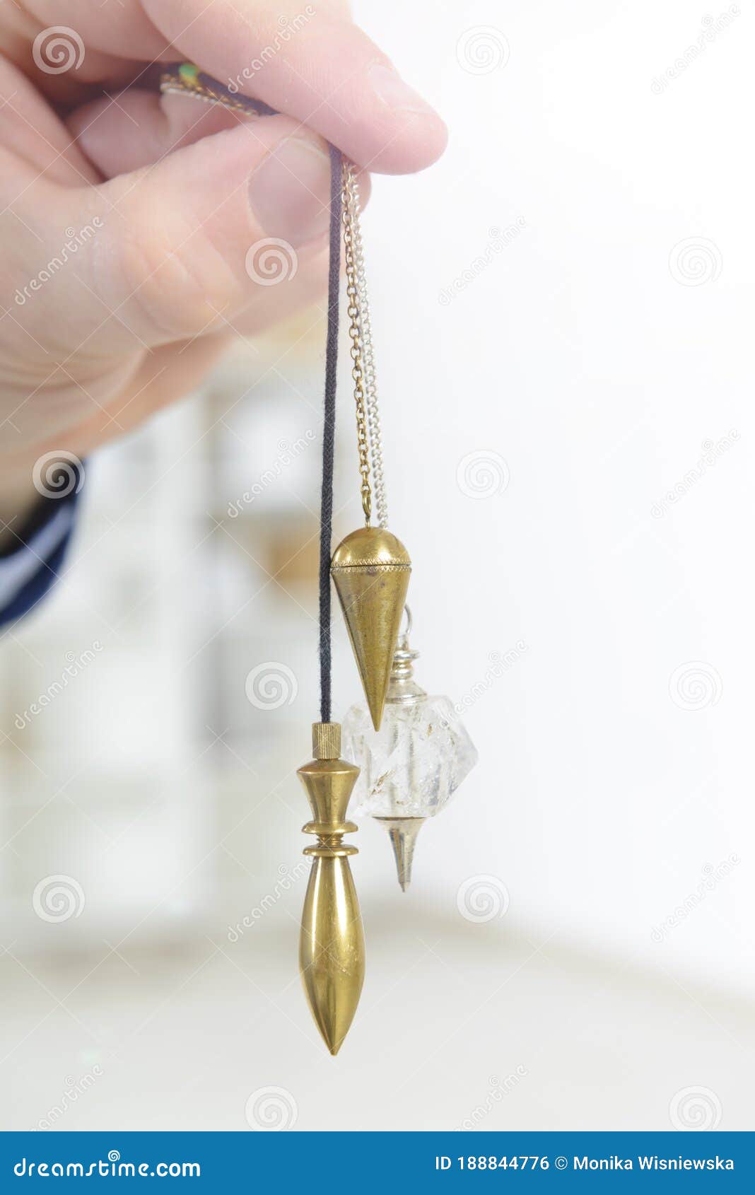 Hand with many pendulums stock photo. Image of metal - 188844776
