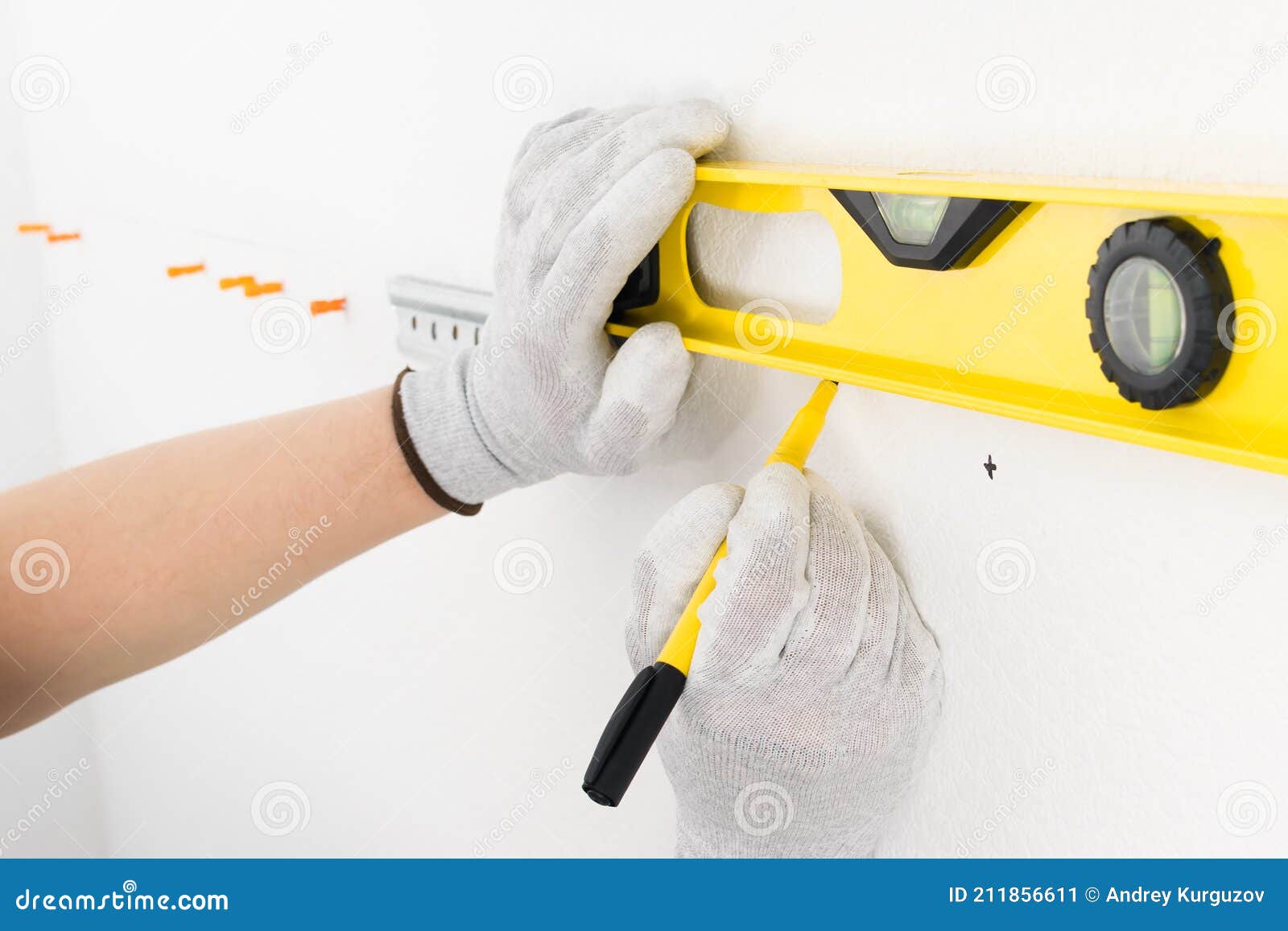 The Hand of the Master Holds the Level Tool and Draws a Straight Line ...