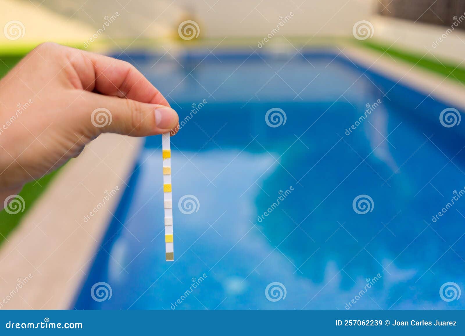 Hand with Measuring Pool Strips To Check Water Quality in a Swimming ...