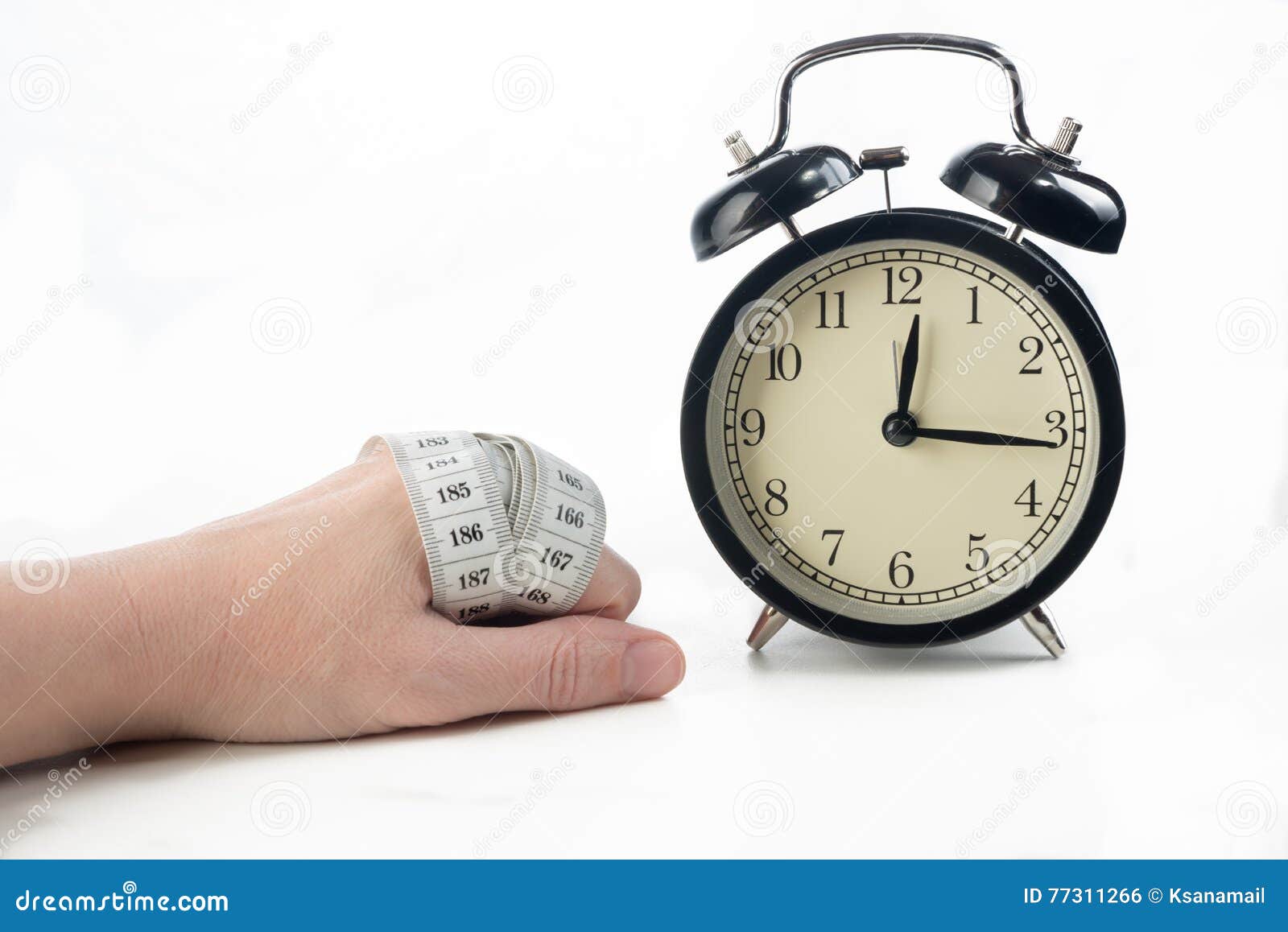 Hand with Measuring Tape and Alarm Clock Stock Photo - Image of indoors ...