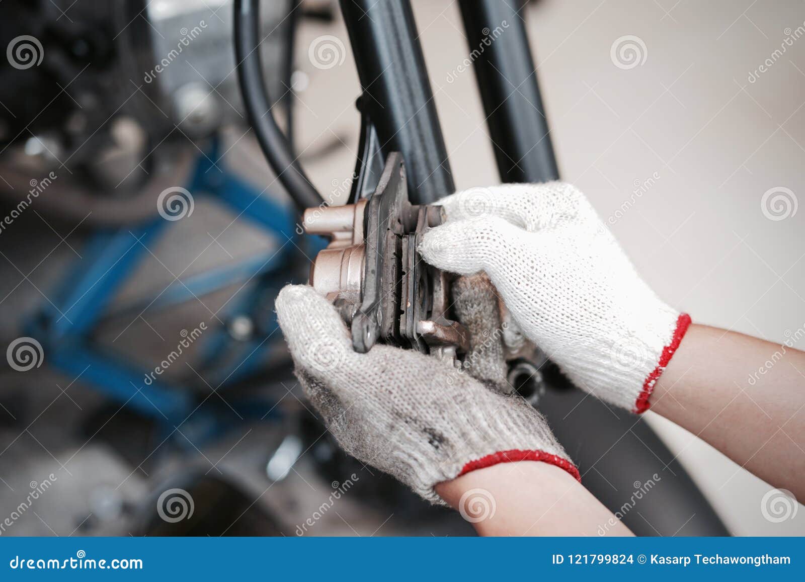 Hand of Mechanic Man Replace and Adjust Motorcycle Rear Brake System ...