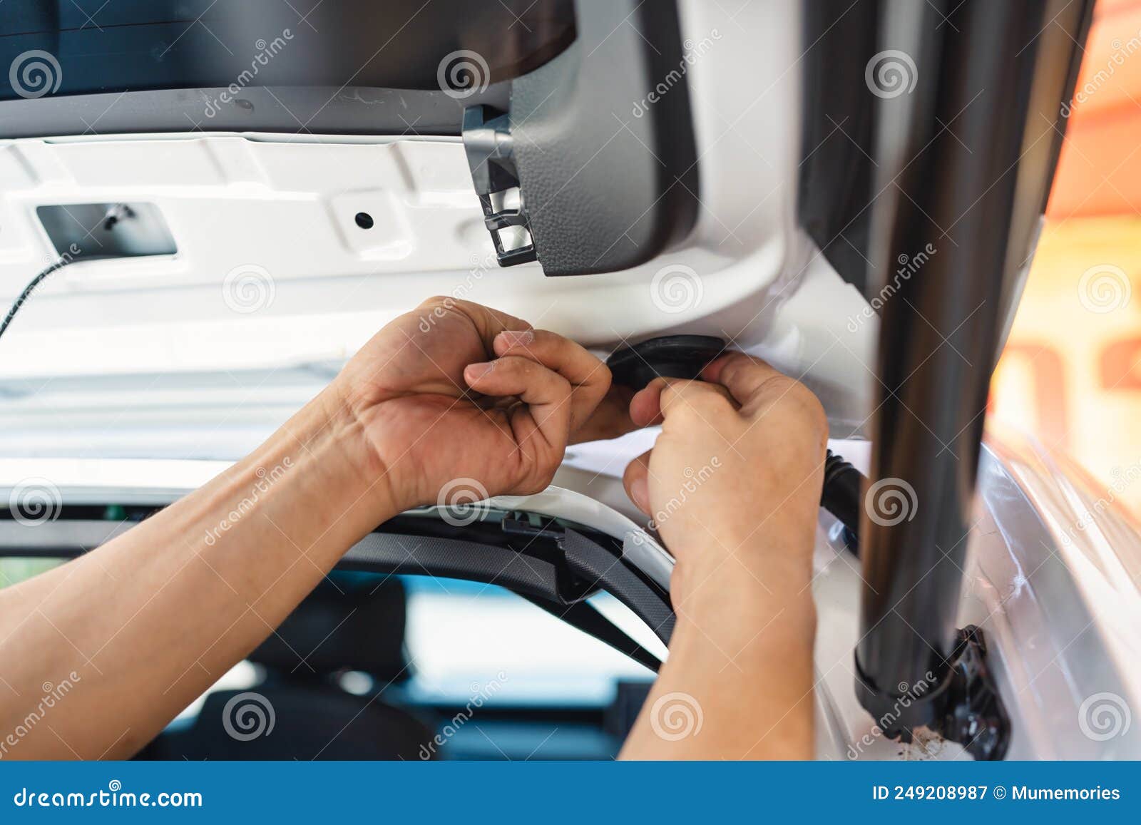 Hand of Mechanic Using Wedge Removing and Installing a Dash Cam Inside ...