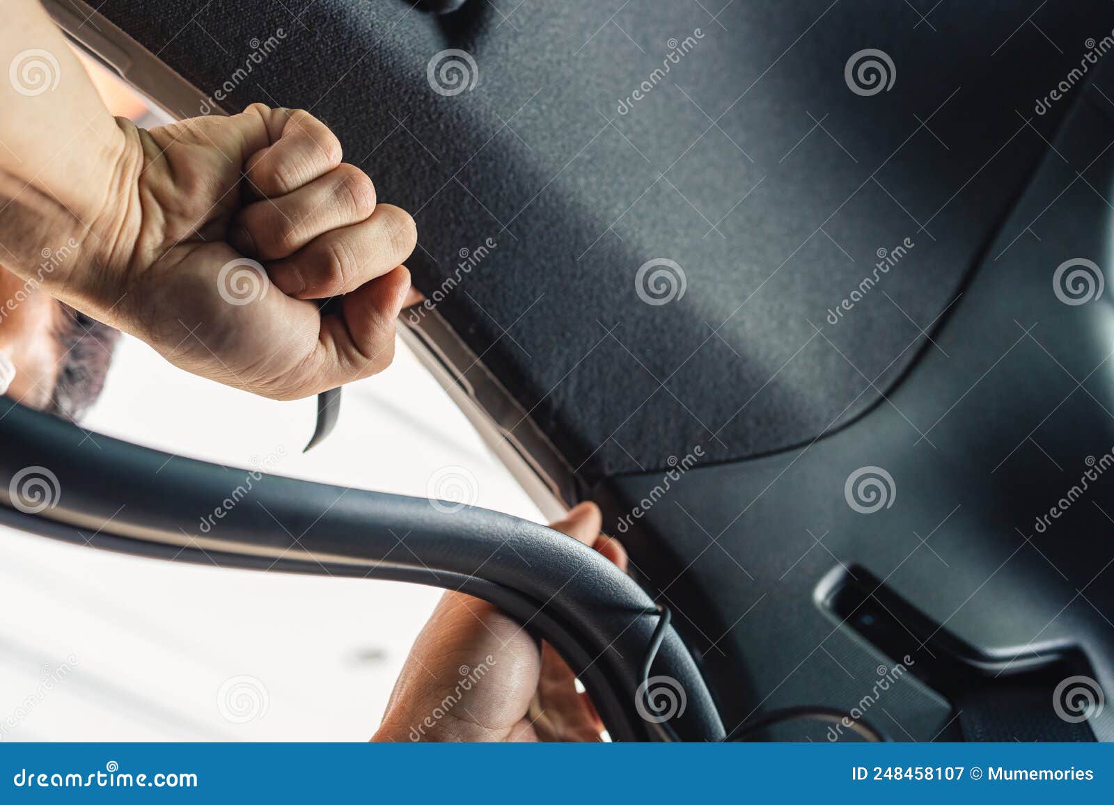 Hand of Mechanic Using Wedge Removing and Installing a Dash Cam Inside ...