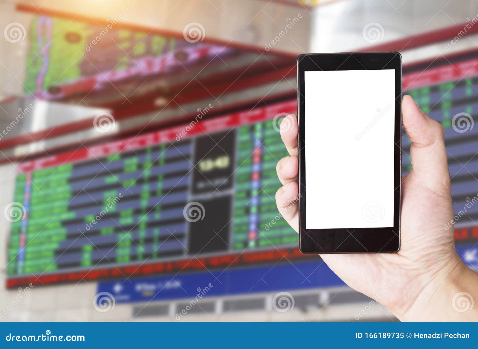 Hand with a Mobile Phone on the Background of an Electronic Scoreboard ...