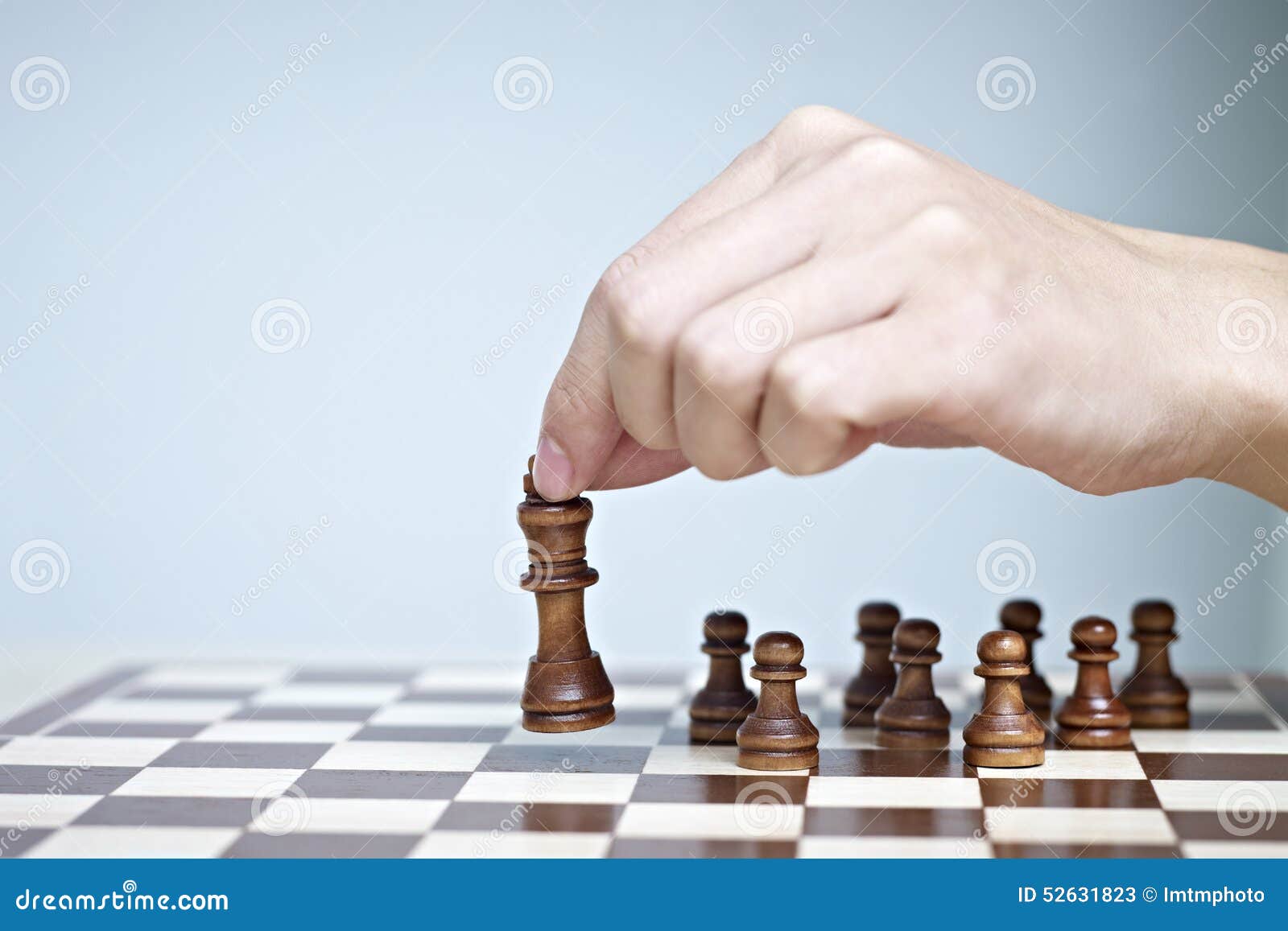 Hand moving a chess piece stock image. Image of conquer - 52631823