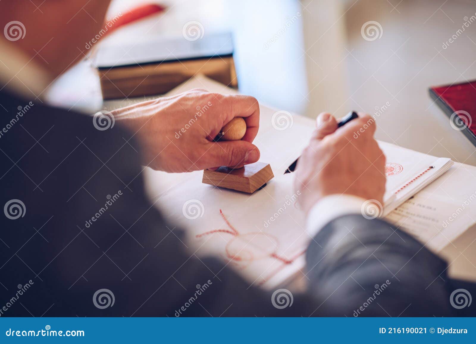 The Hand of a Notary Gives a Stamp on the Document or Certificate ...