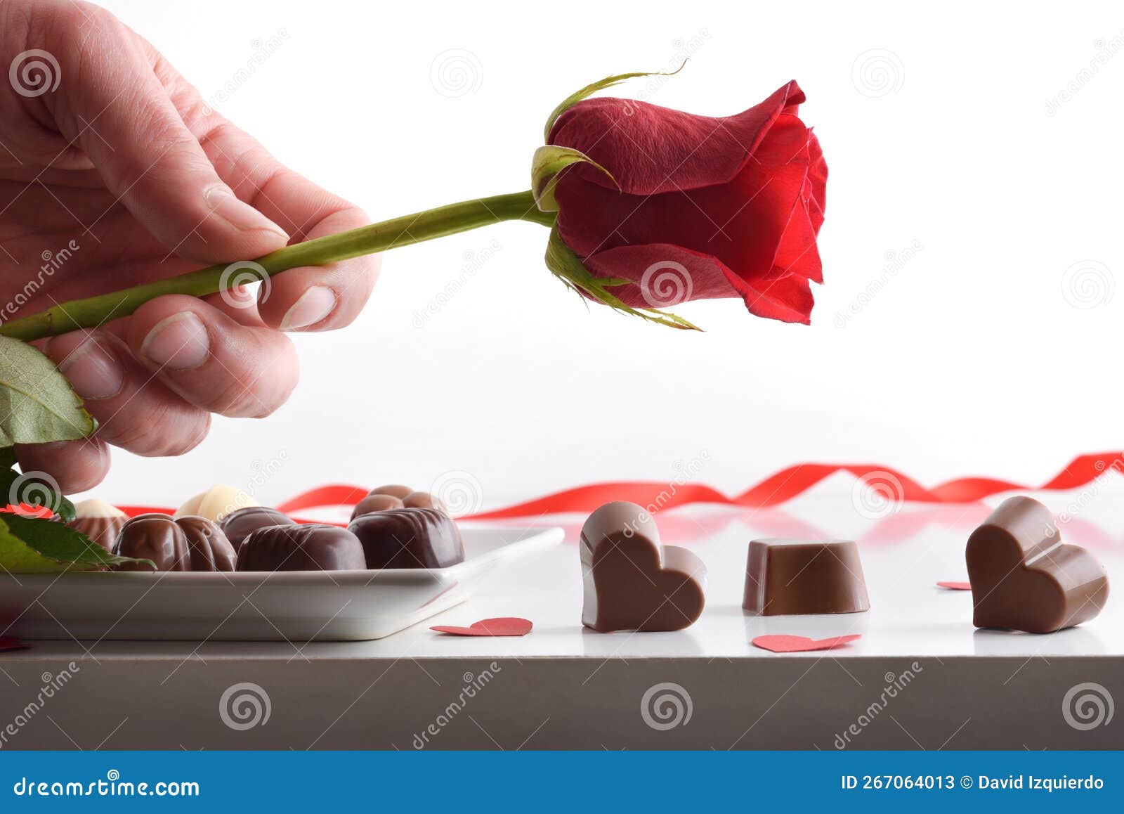 Hand Offering a Rose and Chocolates on White Table Isolated Stock Image ...