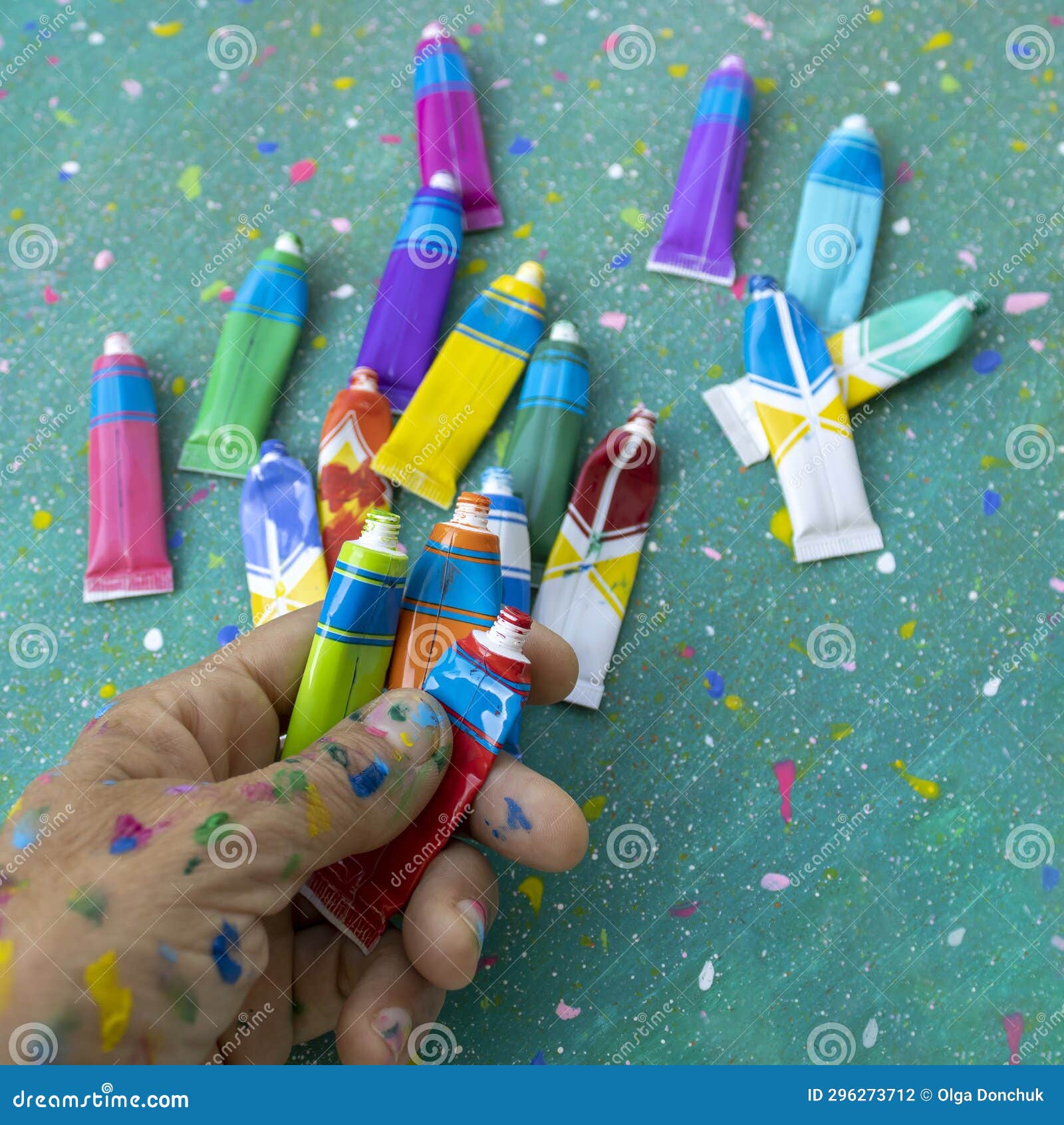 Hand with open paint tubes stock photo. Image of thumb - 296273712