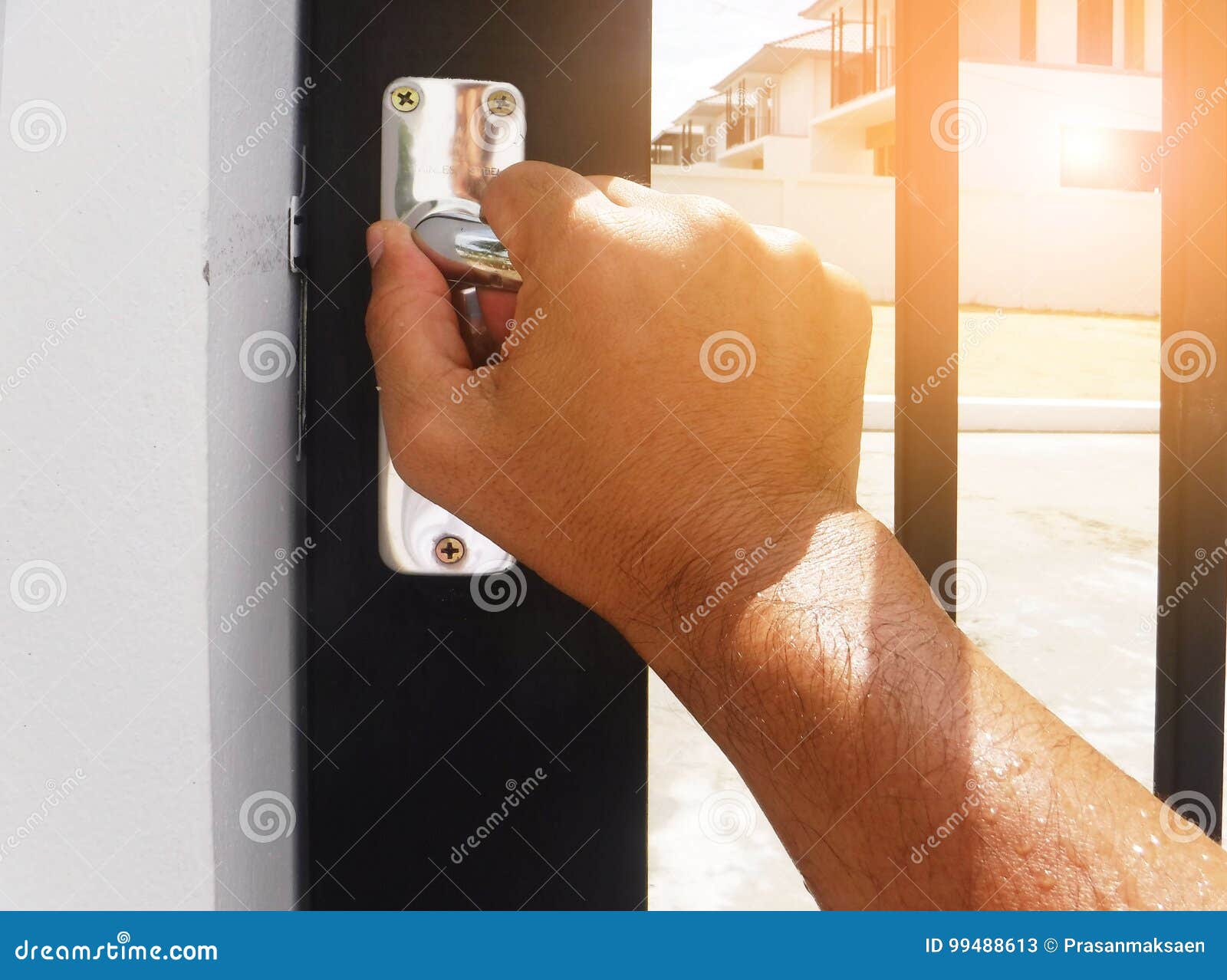 Hand is opening the gate. stock image. Image of metallic - 99488613