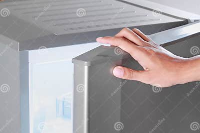 Hand opening refrigerator stock image. Image of clean - 21071371