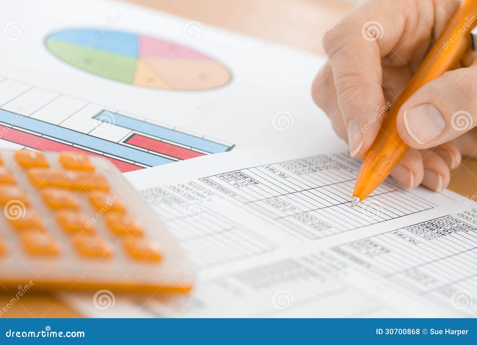Hand with Orange Pen and Calculator Checking Spreadsheet Figures Stock ...