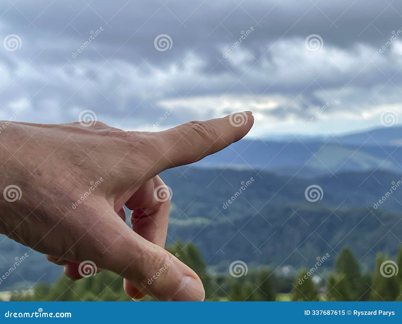 A Hand with an Outstretched Finger Pointing in a Mountainous Area Stock ...
