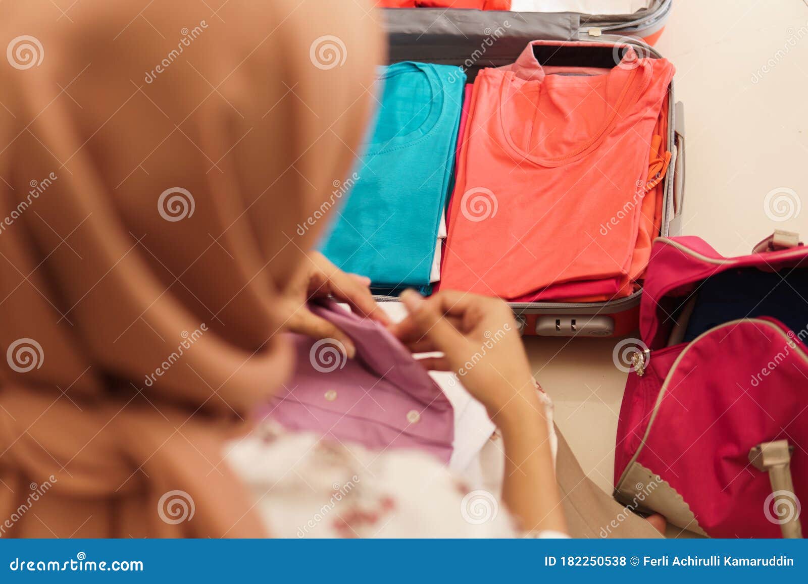 Hand packing on a suitcase stock photo. Image of girl - 182250538