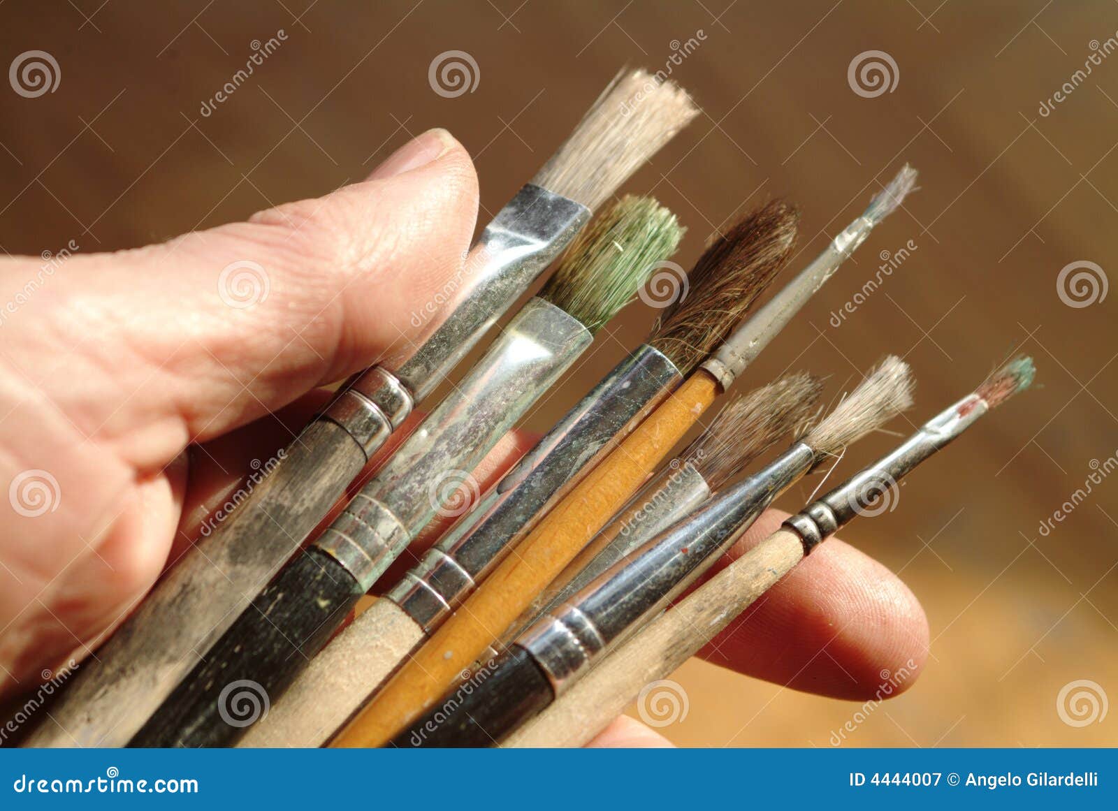 Hand with paint brushes stock image. Image of paint, color - 4444007
